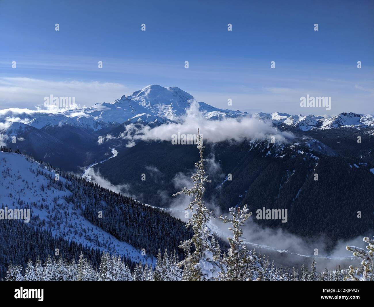An idyllic winter scene of distant snow-capped mountains covered in a ...