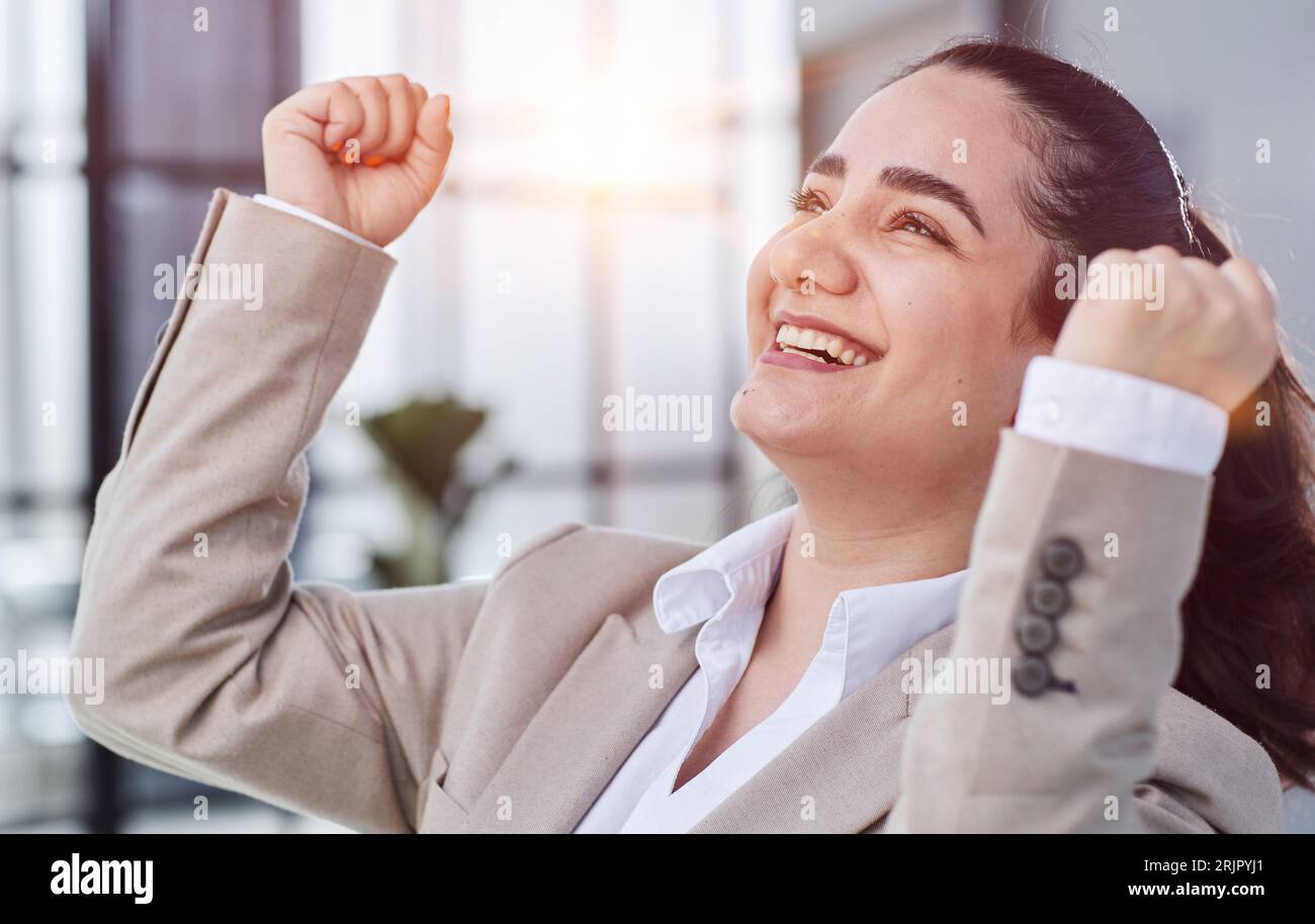 Photo of young overjoyed office assistant girl raise fists up finally ...