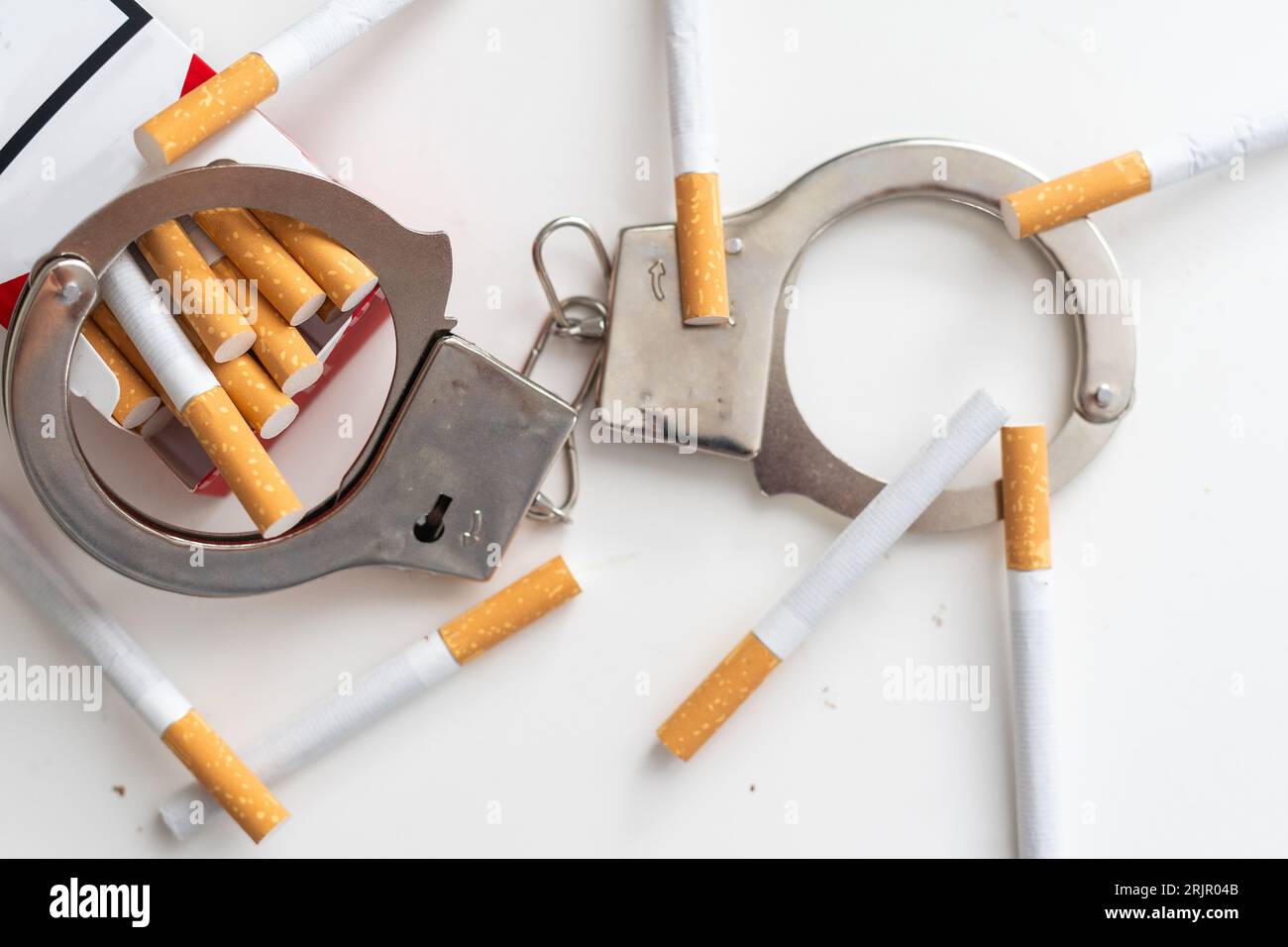 Stop smoking concept. Cigarettes in handcuffs Stock Photo - Alamy