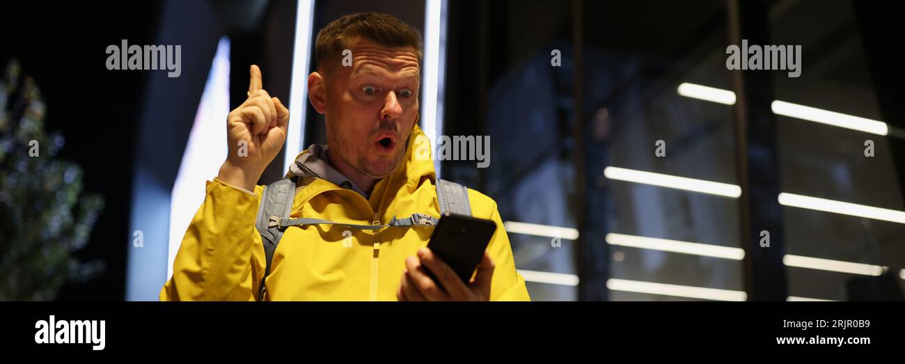 Inspired tourist looks at screen of his smartphone and finds solution ...