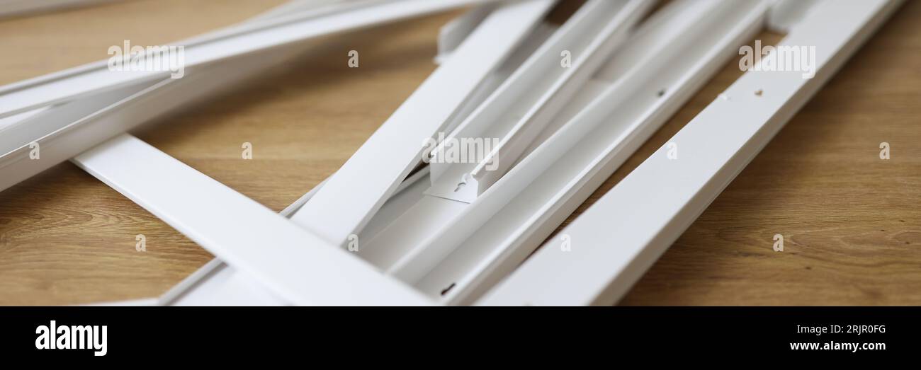 Lots of white plastic cable trays on the wooden floor Stock Photo - Alamy