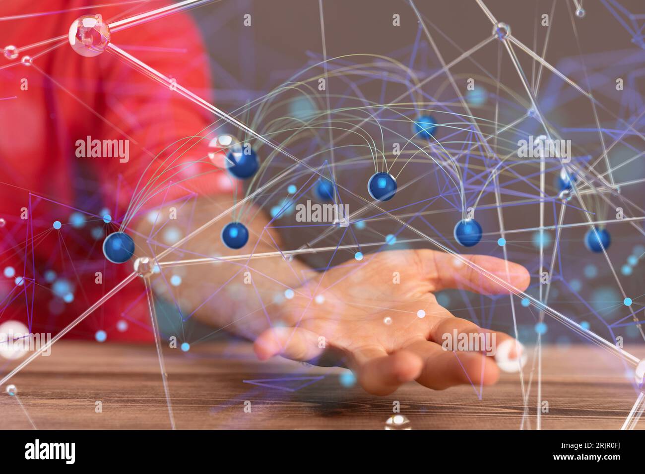 A person reaching his arm under a hologram featuring blue spheres and ...