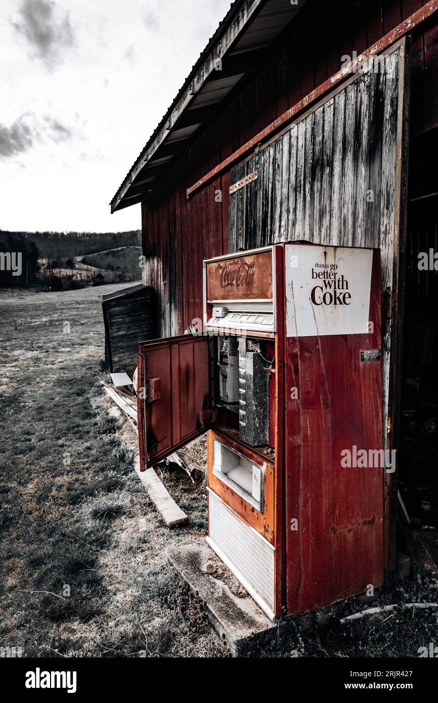 An iconic red Coca-Cola vending machine in front of a vintage ...