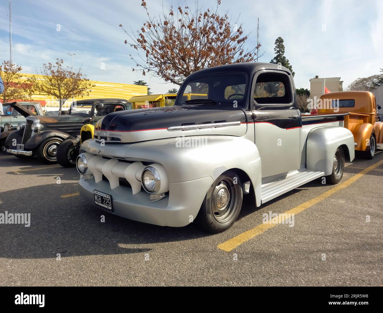 Old black and gray 1950s Ford F 6 V8 cargo pickup truck in a parking ...