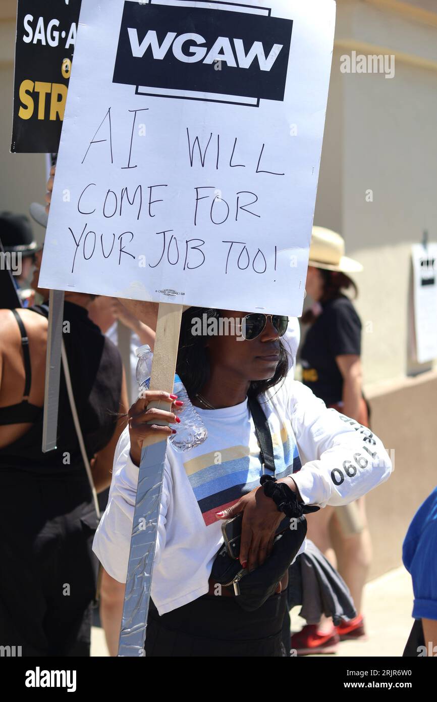 A group of union workers are shown protesting as they walk the picket ...