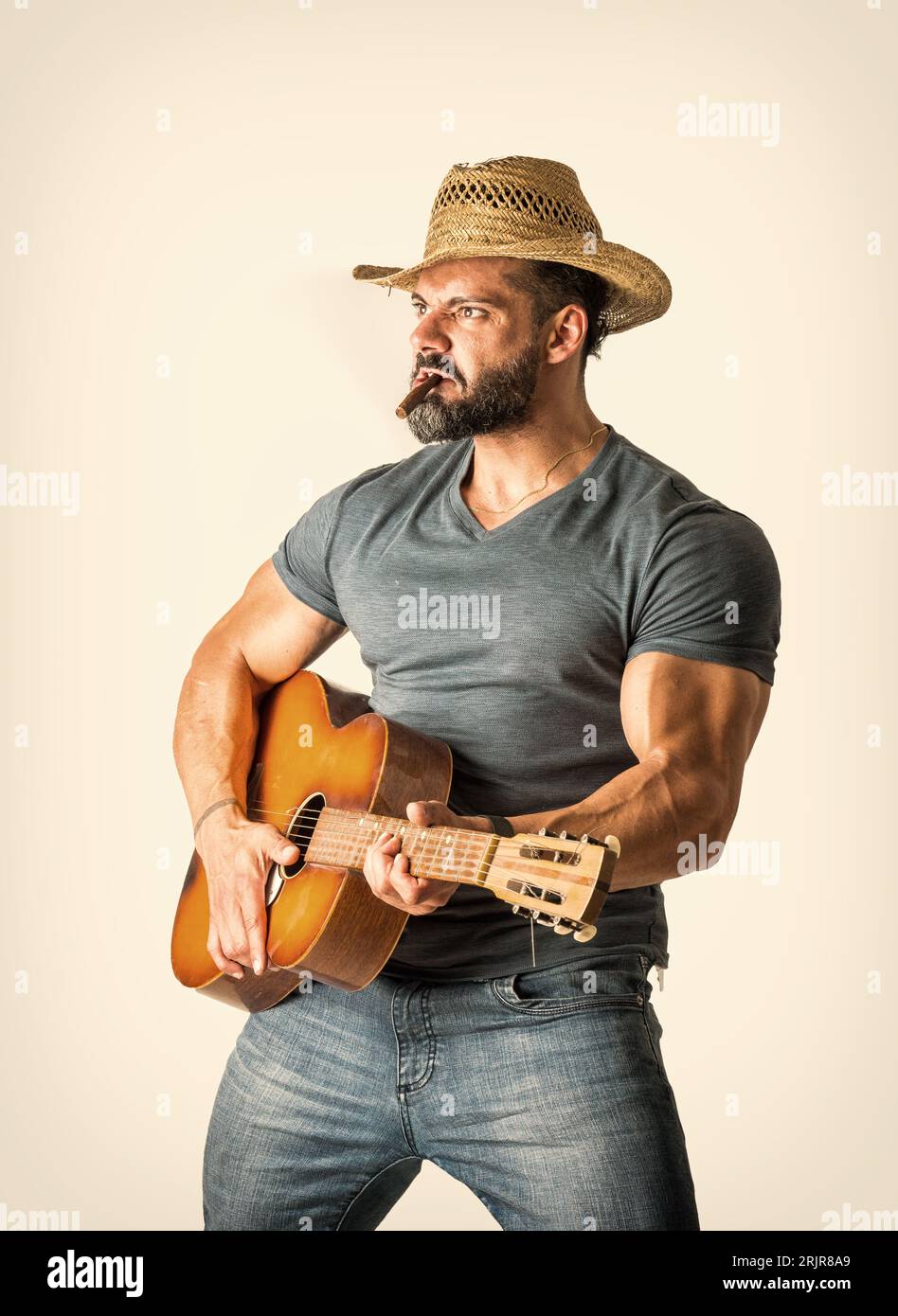 Photo of a muscular man playing a guitar with style and skill Stock ...