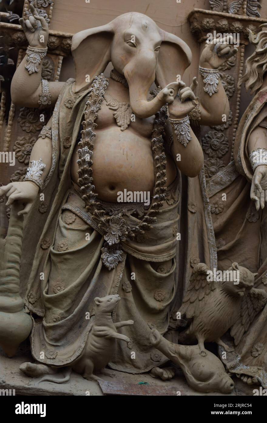 A bronze statue of a Buddhist deity surrounded by an adoring ...