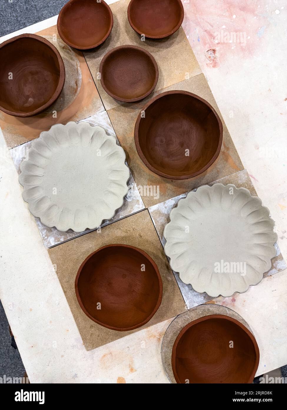 Greenware ceramic plates and bowls from various clay bodies Stock Photo ...