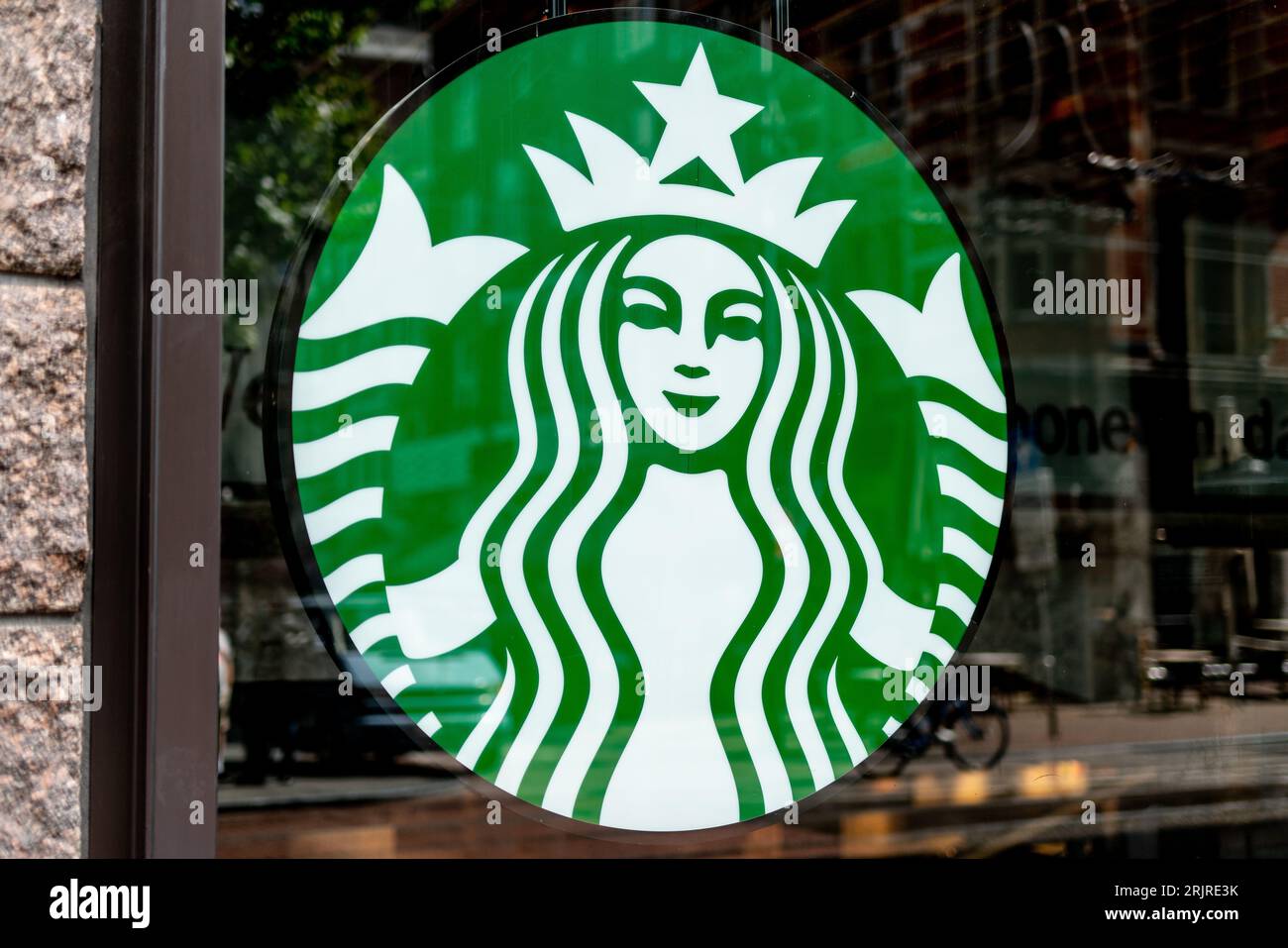 A closeup of the Starbucks logo in the window of a cafe in Amsterdam ...