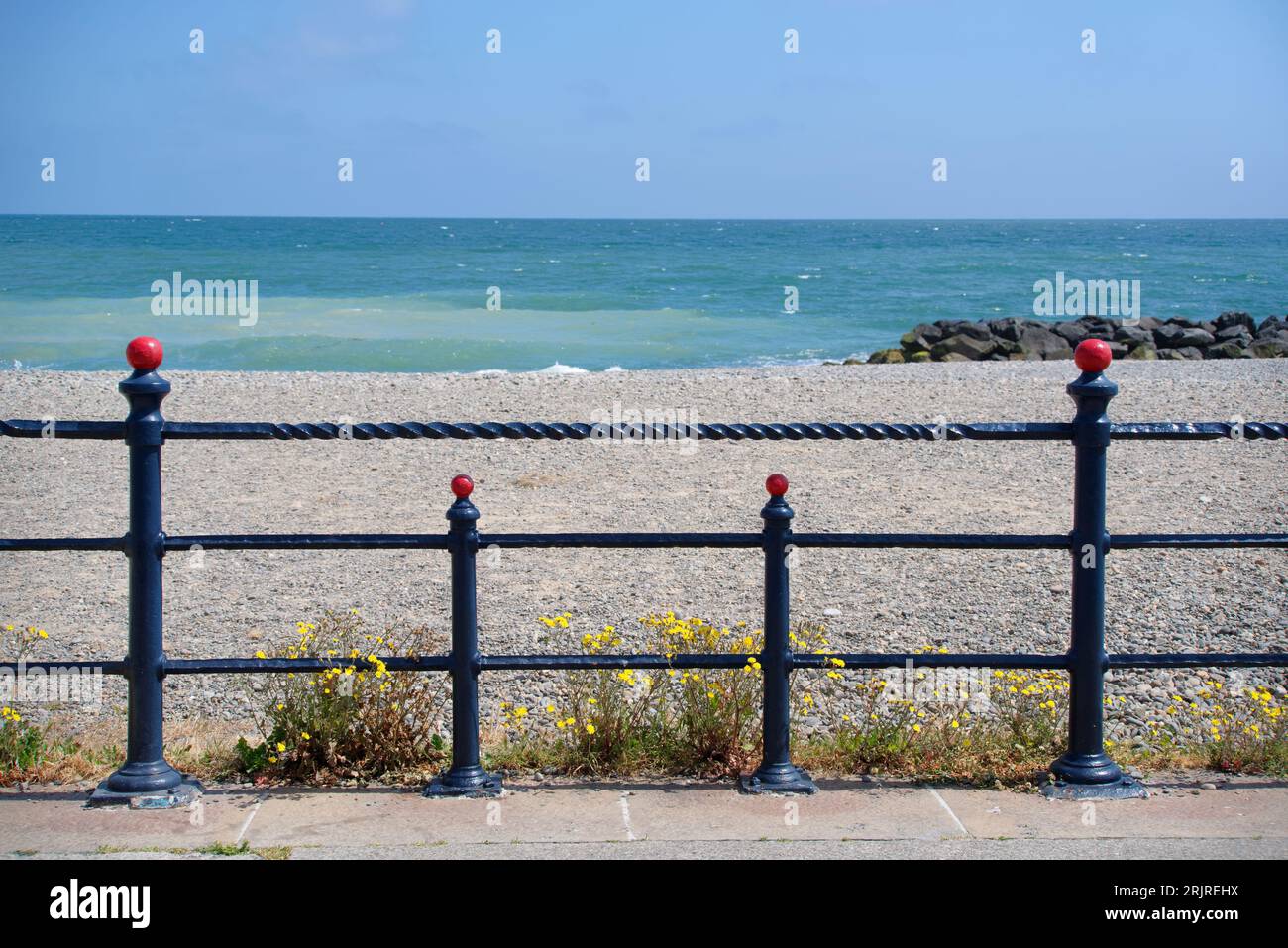 Seascape with the Irish Sea and pebble beach seen through symmetrical ...