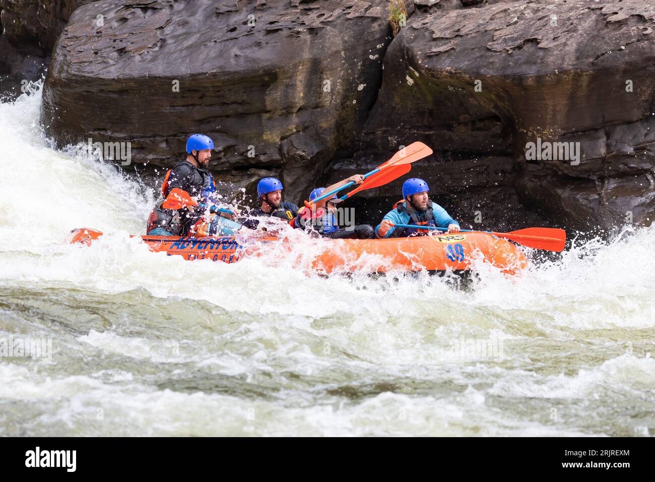 A diverse group of people rafting together in a flowing river Stock ...