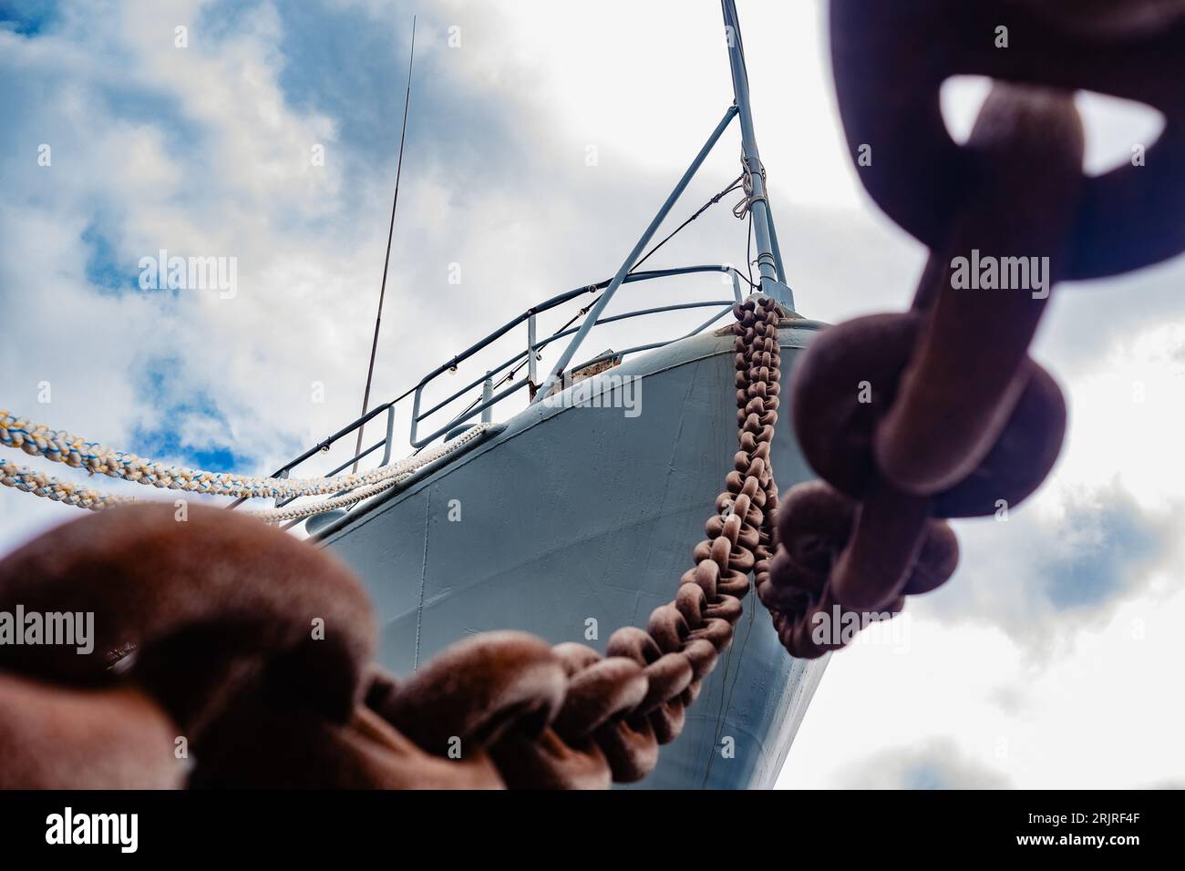 Bow of an old military ship, chained to the port, steel plates Stock ...