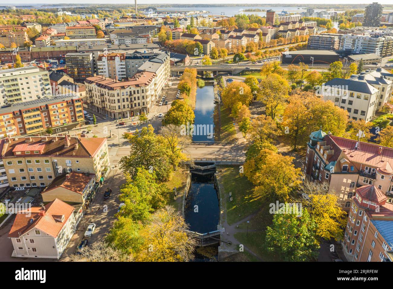 An aerial view of a bustling waterfront cityscape, with a winding river ...