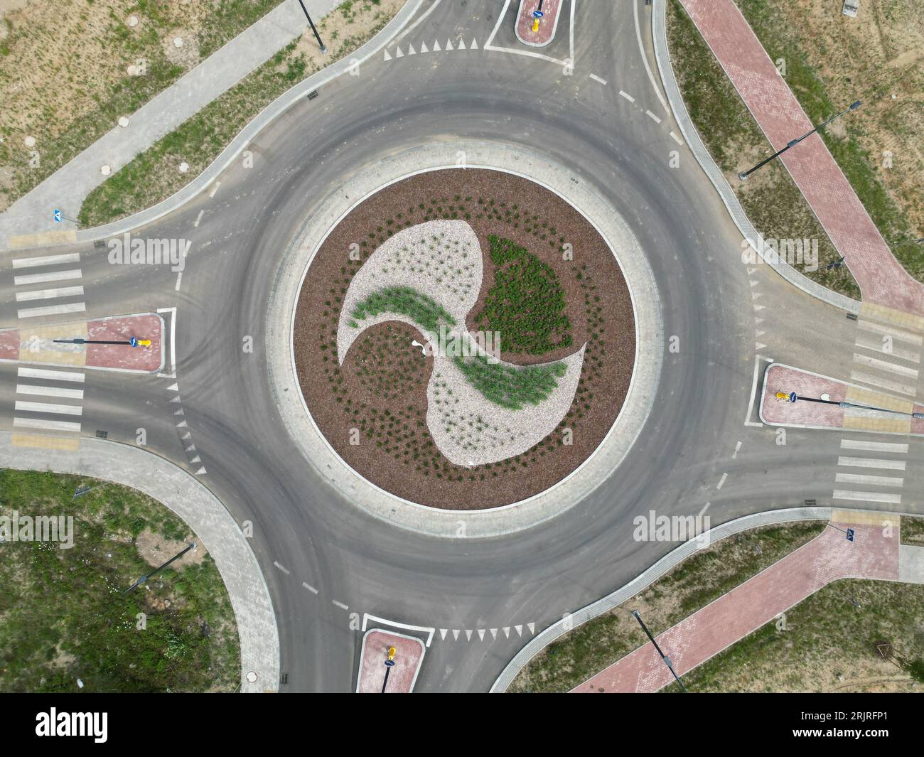 An aerial view of a traffic roundabout, showing the junction of ...