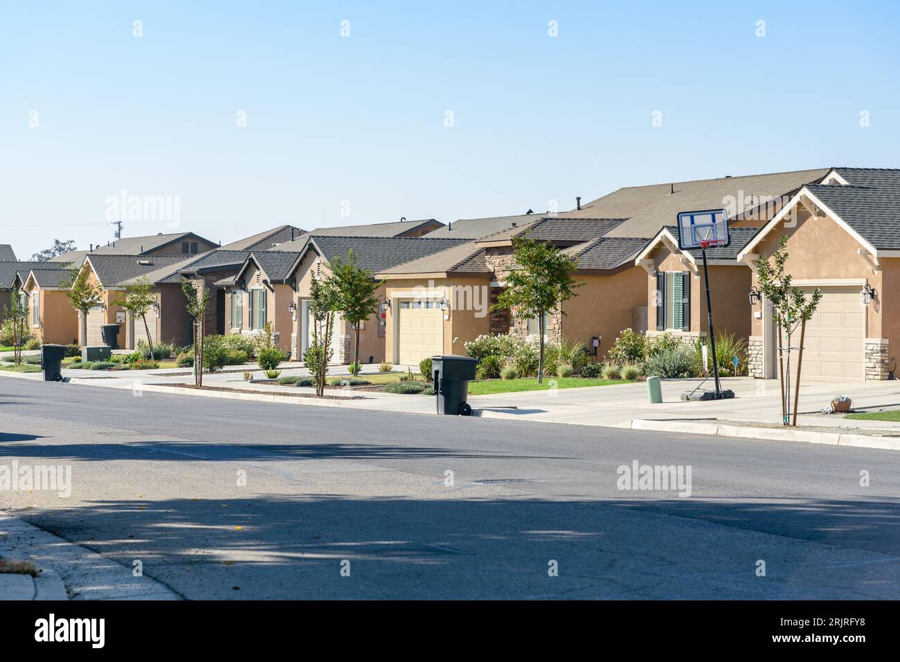 Detached houses along a street in a housing development on a clear ...