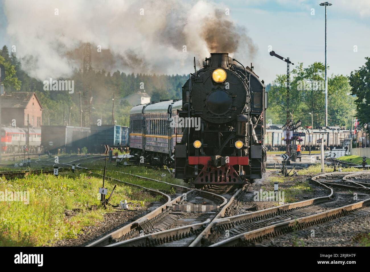 Retro steam train departs from the platform Stock Photo - Alamy