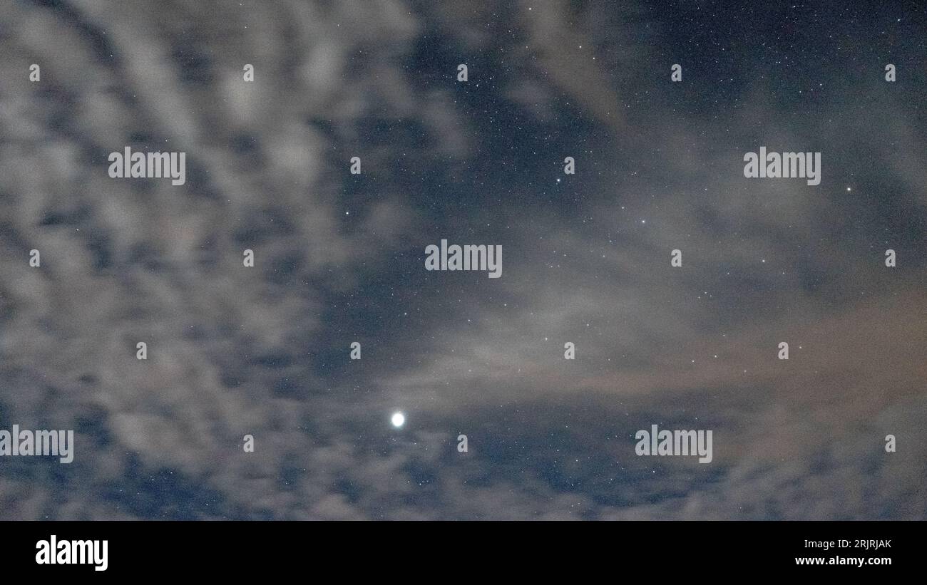 A night sky filled with an array of fluffy clouds illuminated by starlight Stock Photo - Alamy