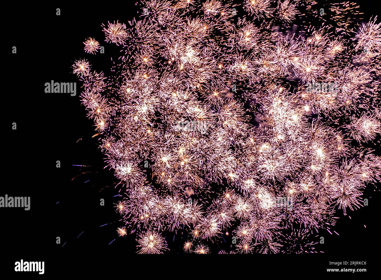 A vibrant display of pyrotechnic fireworks lighting up the night sky ...