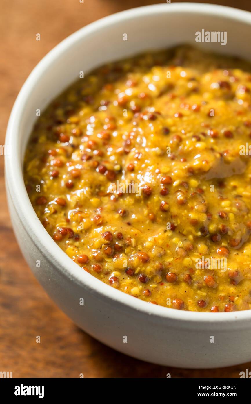 Organic Brown Spicy Grainy Mustard in a Bowl Stock Photo - Alamy