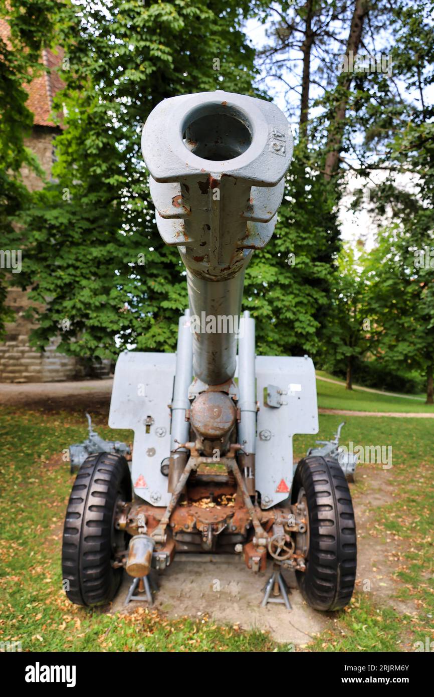 An antique machine featuring four metal wheels resting in a grassy ...