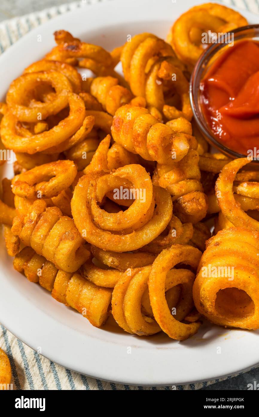 Seasoned Homemade Curly French Fries with Ketchup Stock Photo - Alamy