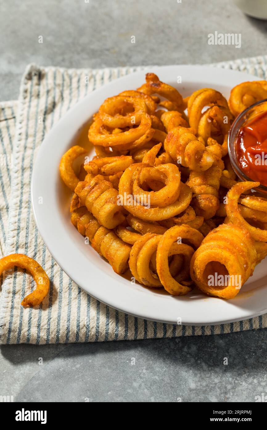 Seasoned Homemade Curly French Fries with Ketchup Stock Photo - Alamy