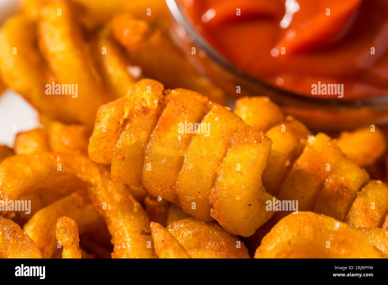 Seasoned Homemade Curly French Fries with Ketchup Stock Photo - Alamy