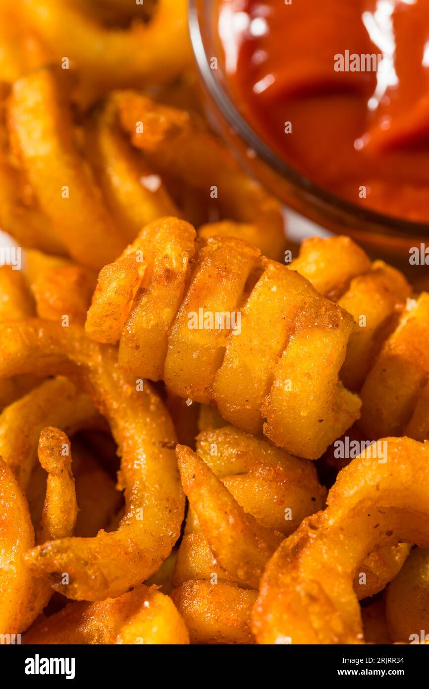 Seasoned Homemade Curly French Fries with Ketchup Stock Photo - Alamy