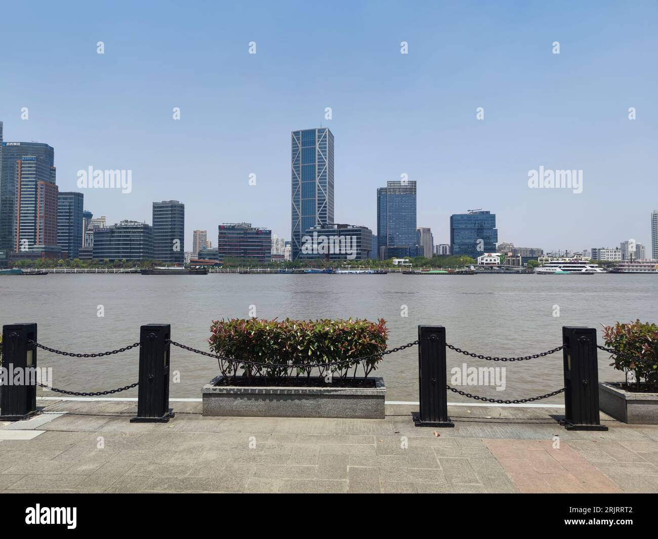 a city skyline with a body of water in the foreground, featuring ...