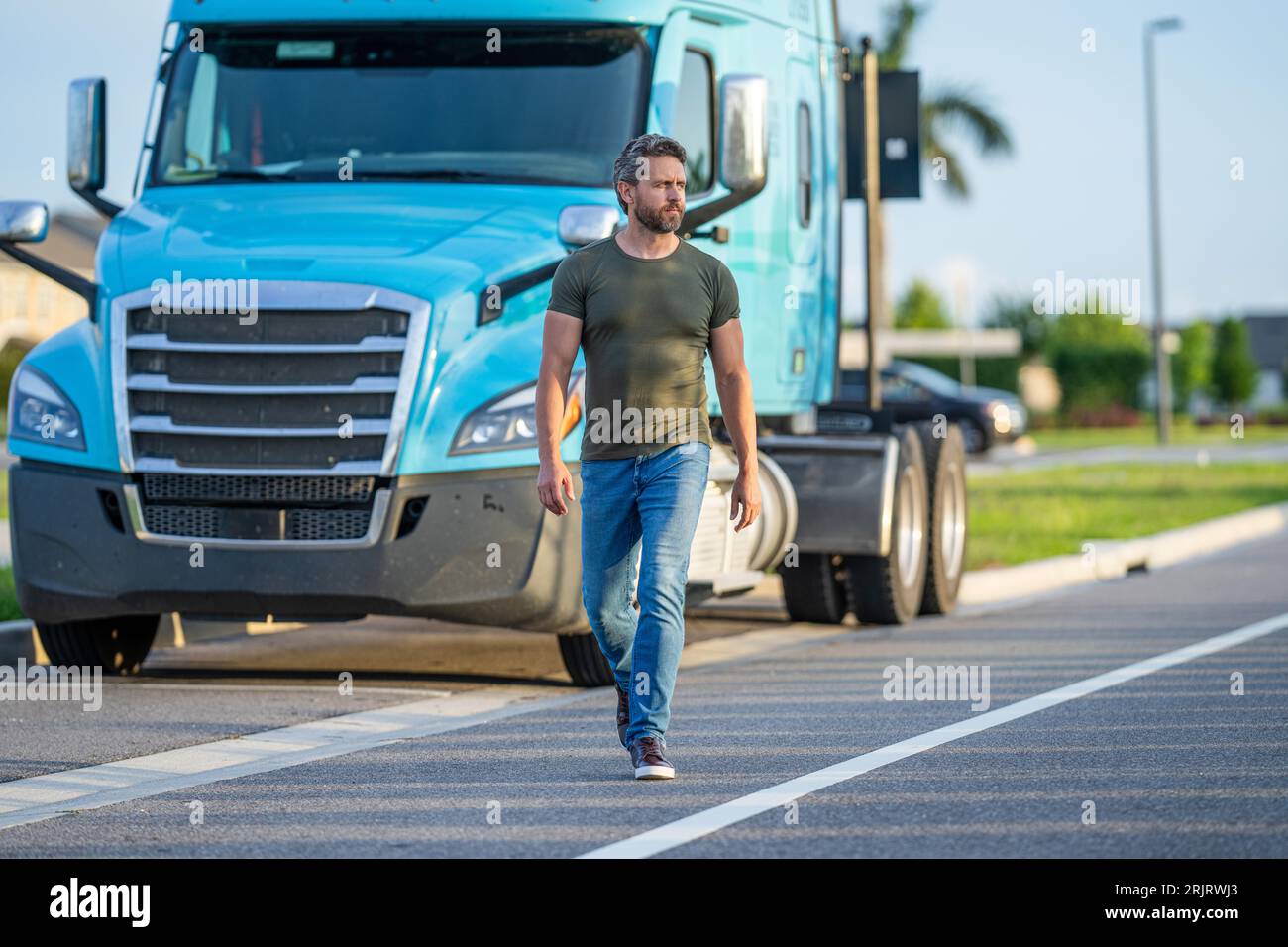 hispanic man posing in front of truck. Semi trucks vehicle. man driver ...