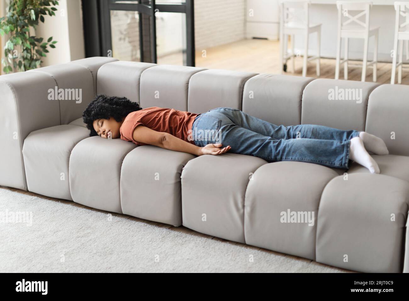 Person lying on couch hi-res stock photography and images - Alamy