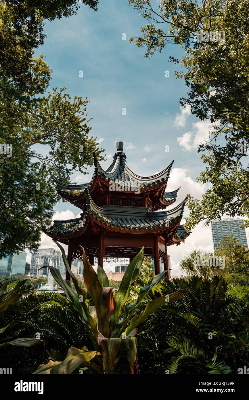 An ornate Asian-style building surrounded by lush trees in downtown ...