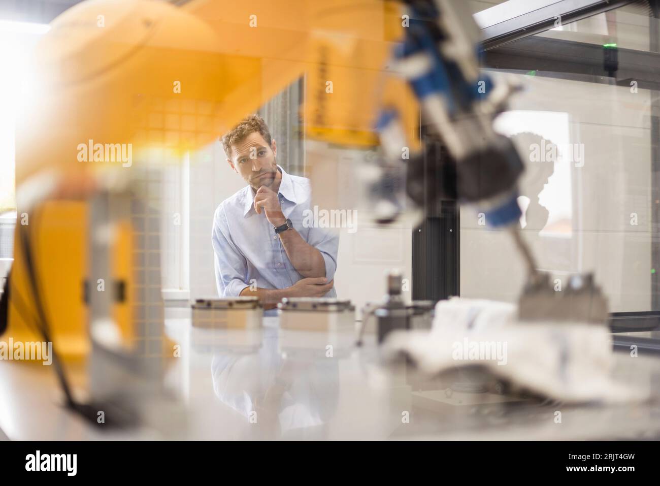 Businessman checking industrial robot in high tech company Stock Photo ...