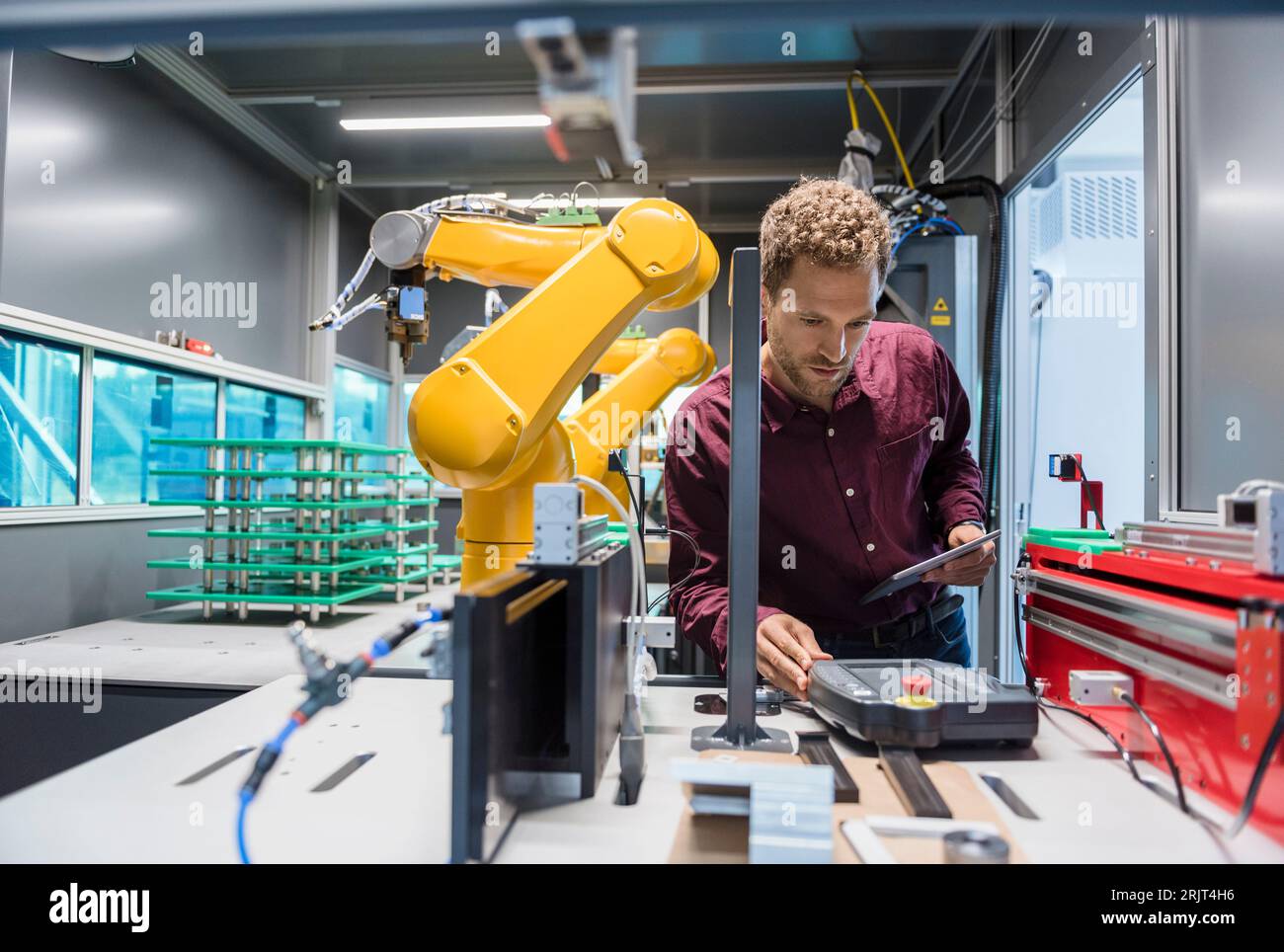 Businessman checking industrial robot in high tech company Stock Photo ...
