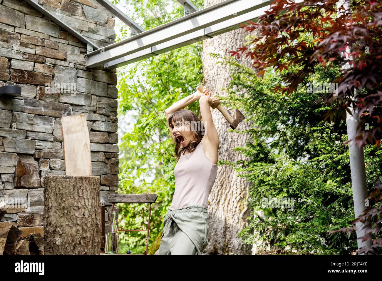 Woman chopping wood outdoors hi-res stock photography and images - Alamy