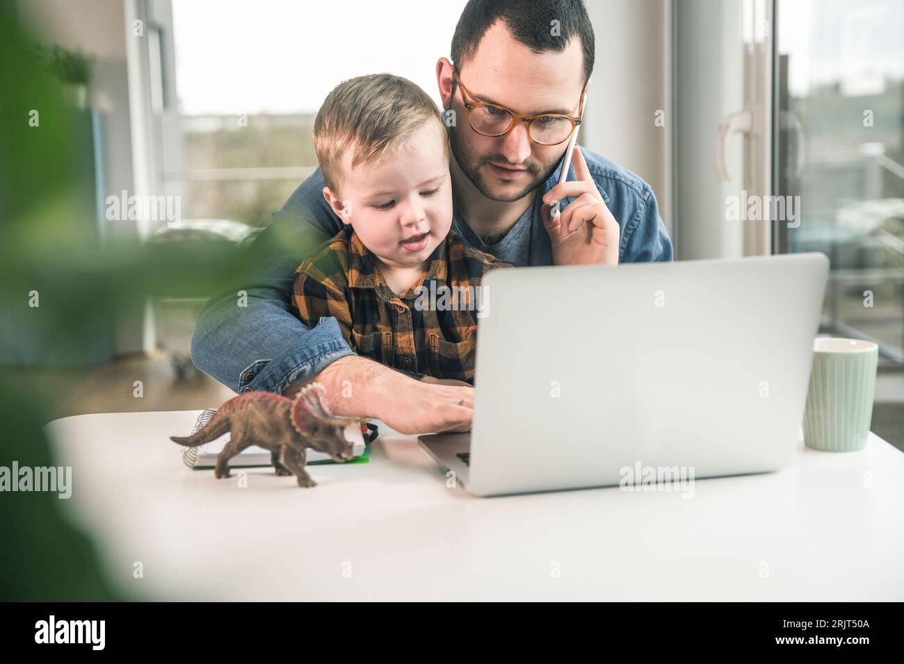 Busy father working laptop hi-res stock photography and images - Alamy