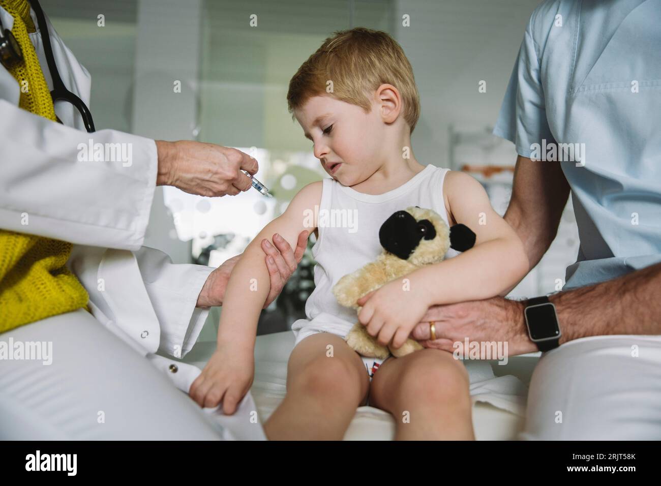 Pediatrist injecting vaccine into arm of unhappy toddler Stock Photo ...