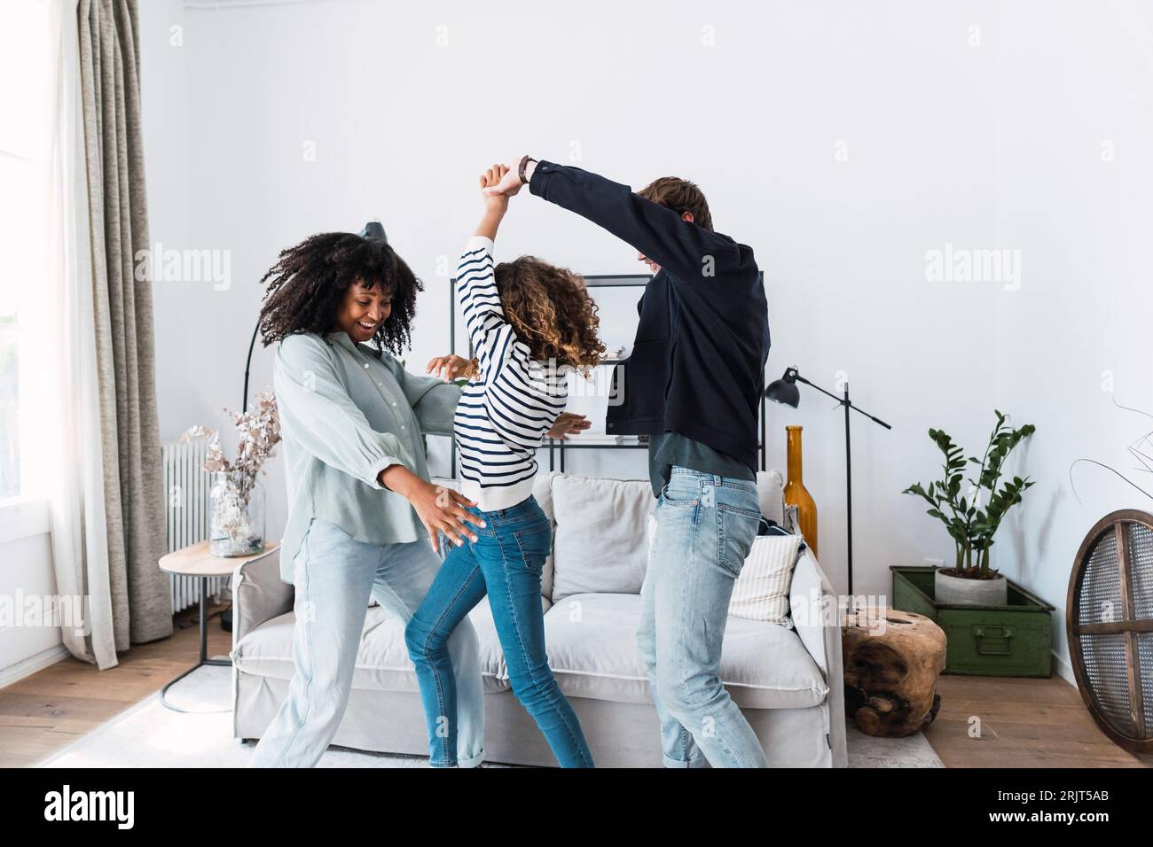 Happy family havin fun dancing together in the living room Stock Photo ...
