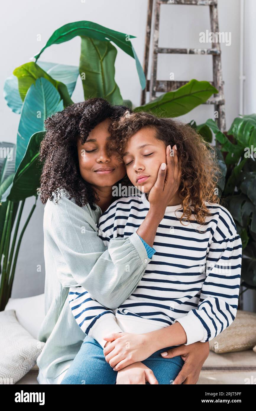mother consoling sad daughter stroking her cheek Stock Photo - Alamy