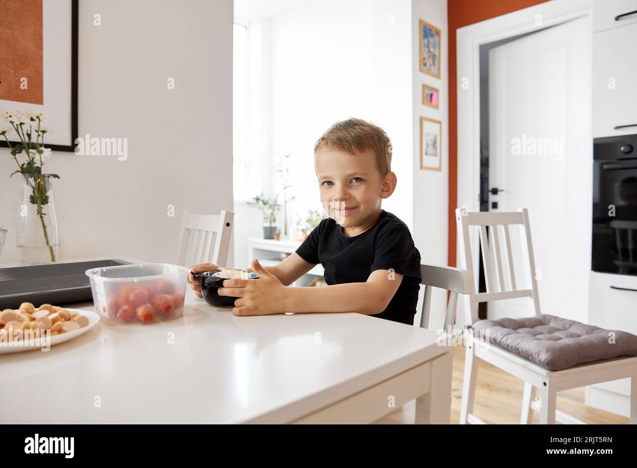 Boy sitting at kitchen table hi-res stock photography and images - Alamy