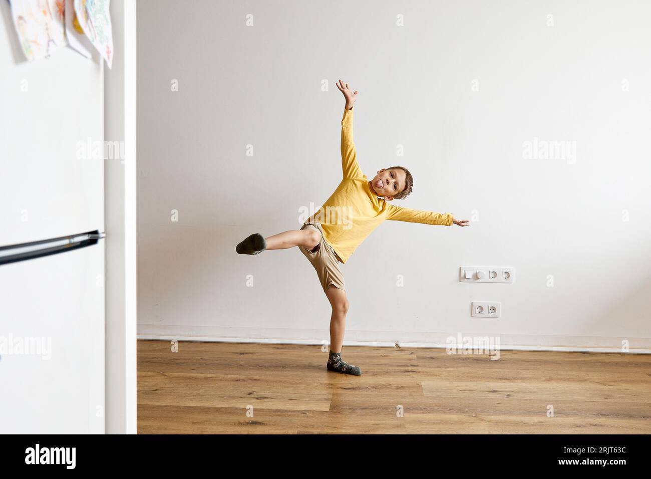 Happy boy doing mischief and having fun in front of white wall Stock ...