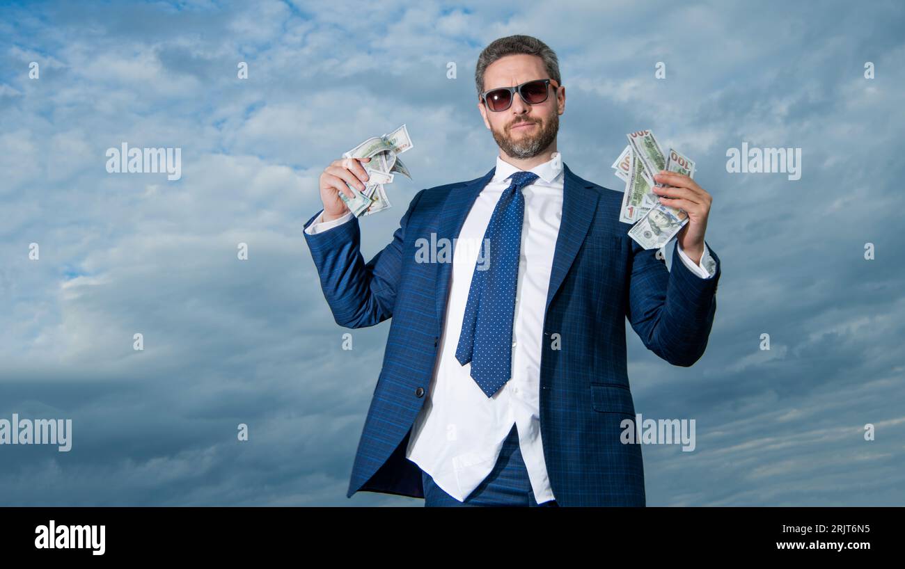 riches of man with money on sky background with copy space. riches of ...