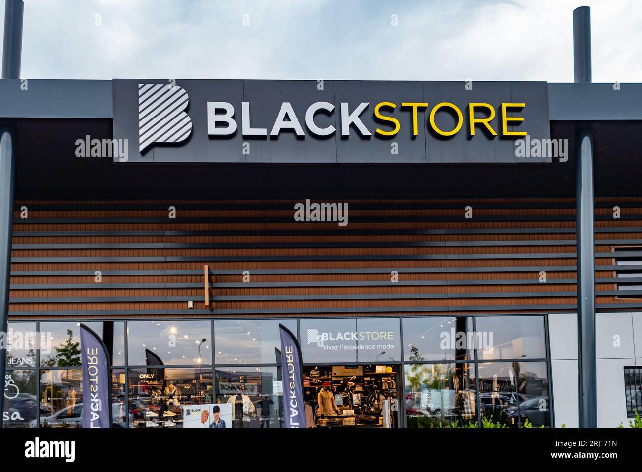 An elevated view of a modern retail store entrance, featuring a large ...