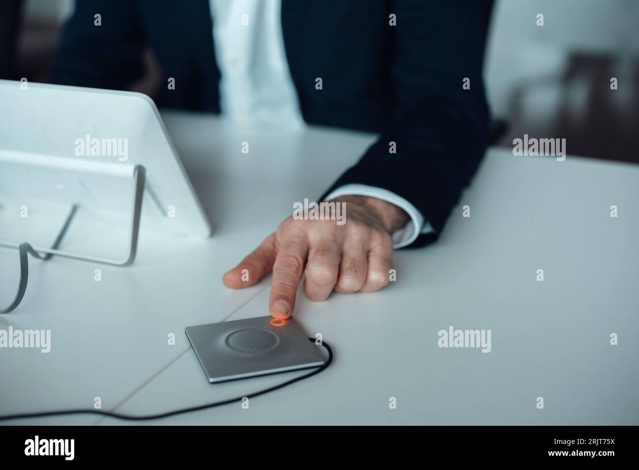 Hand of businessman pushing button at desk Stock Photo - Alamy