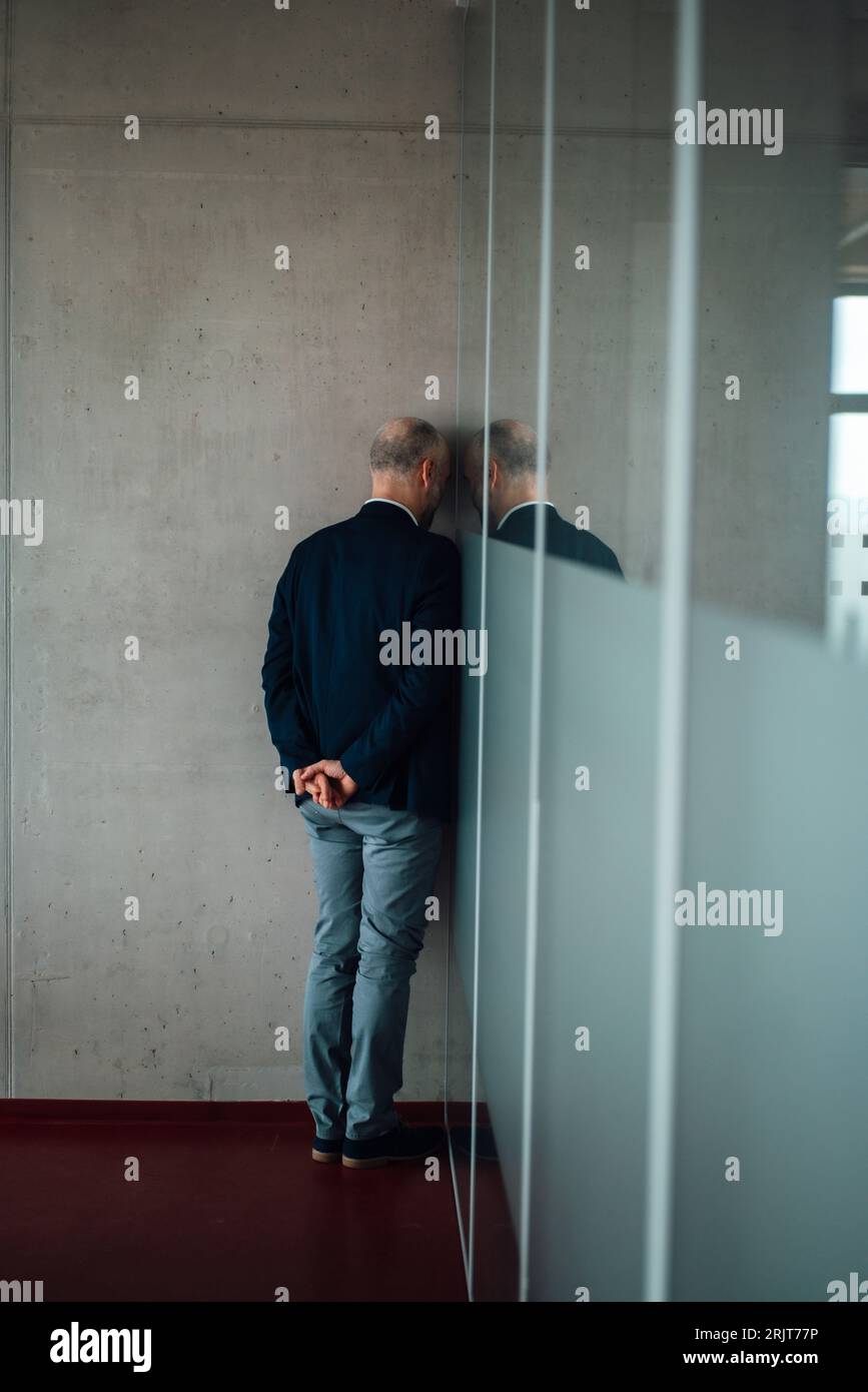 Businessman standing in corner office hi-res stock photography and ...