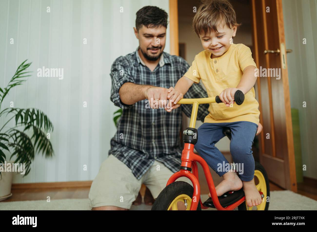 Smiling father helping son hi-res stock photography and images - Alamy