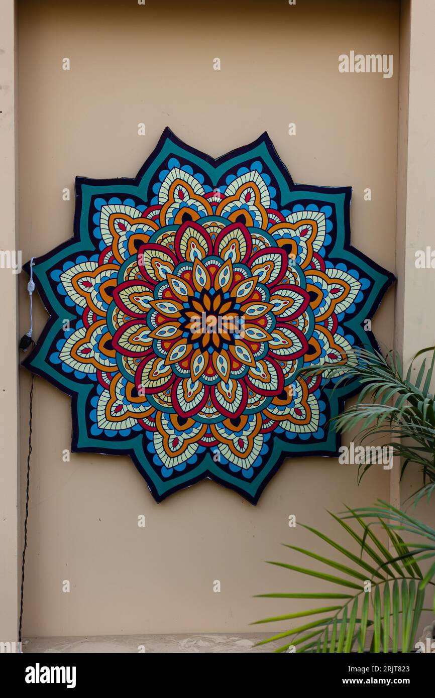 This image depicts the intricate art of a mandala, a geometric and ...