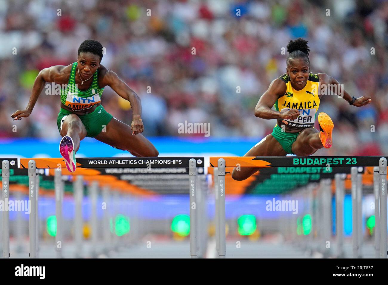 Tobi Amusan, of Nigeria, left, and Megan Tapper, of Jamaica compete in ...