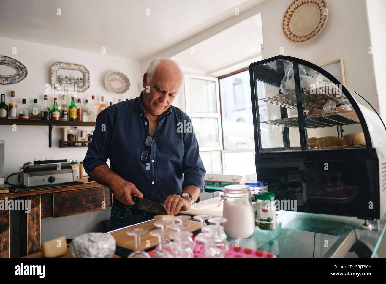 Cafe owner preparing food in coffee shop Stock Photo - Alamy