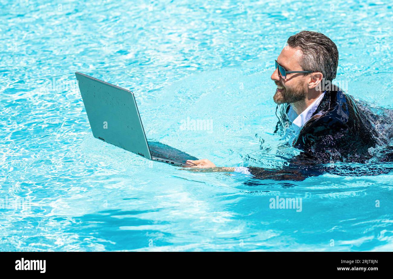 Businessman in suit with laptop in swimming pool. business man on ...